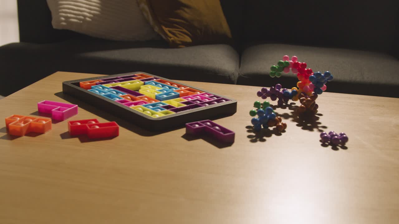 Free stock video - Coloured interlocking shape puzzles on table at home ...