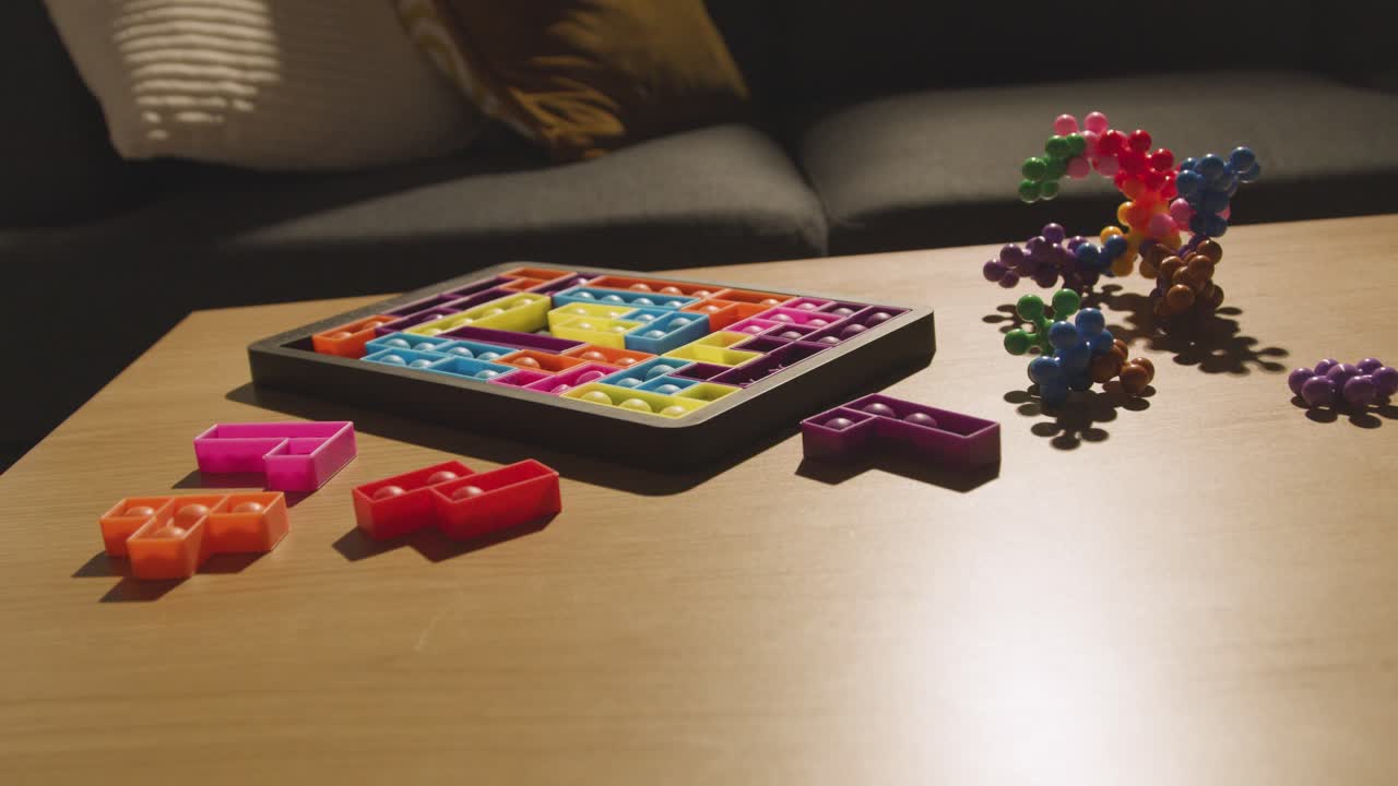 Free stock video - Coloured interlocking shape puzzles on table at home ...