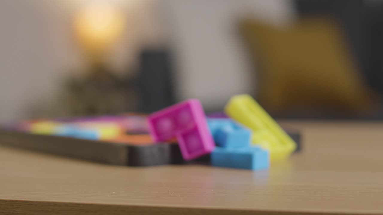 Free stock video - Coloured interlocking shape puzzle on table at home ...