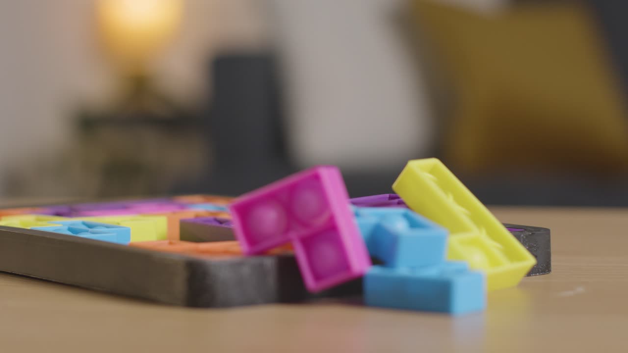 Free stock video - Coloured interlocking shape puzzle on table at home ...