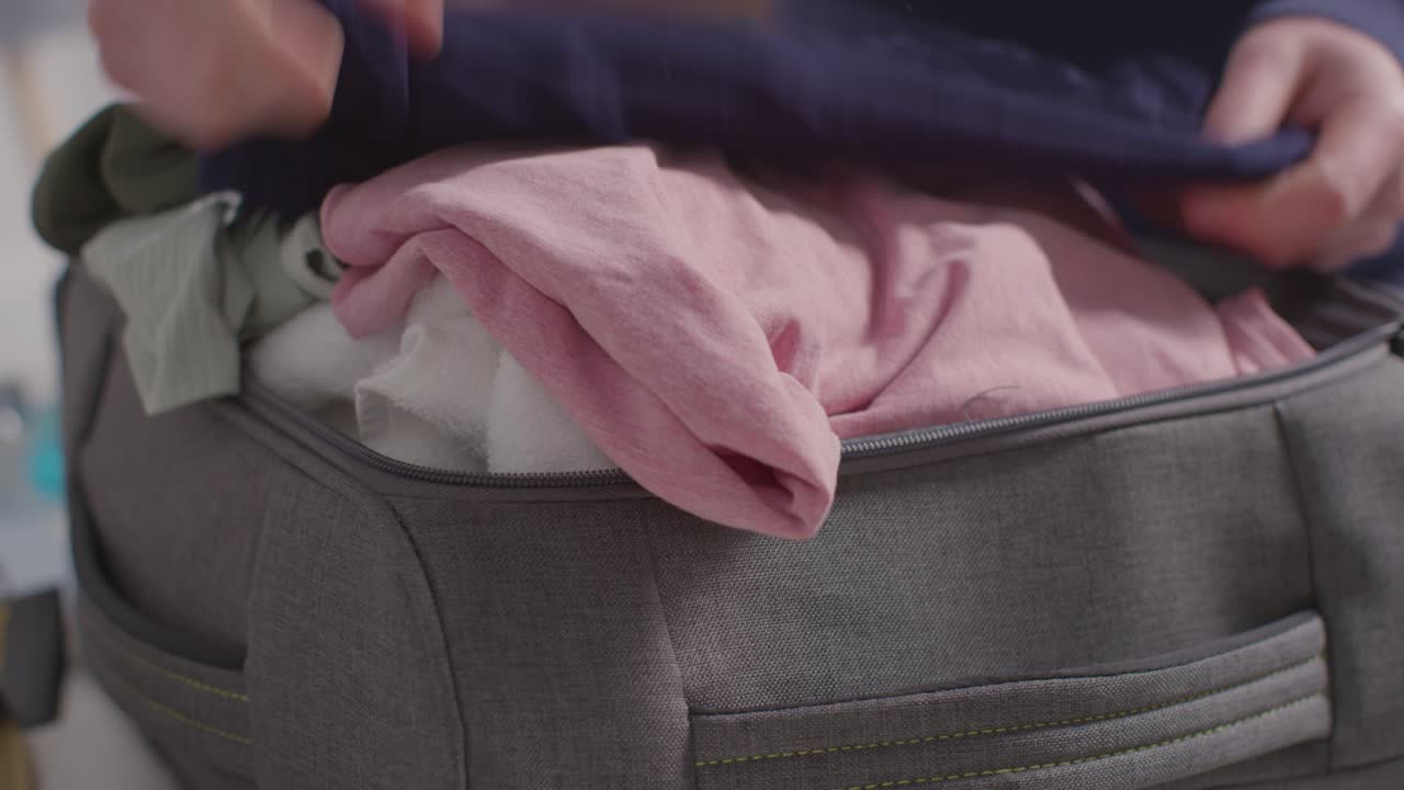 Free stock video - Close up of person packing clothes into suitcase ...