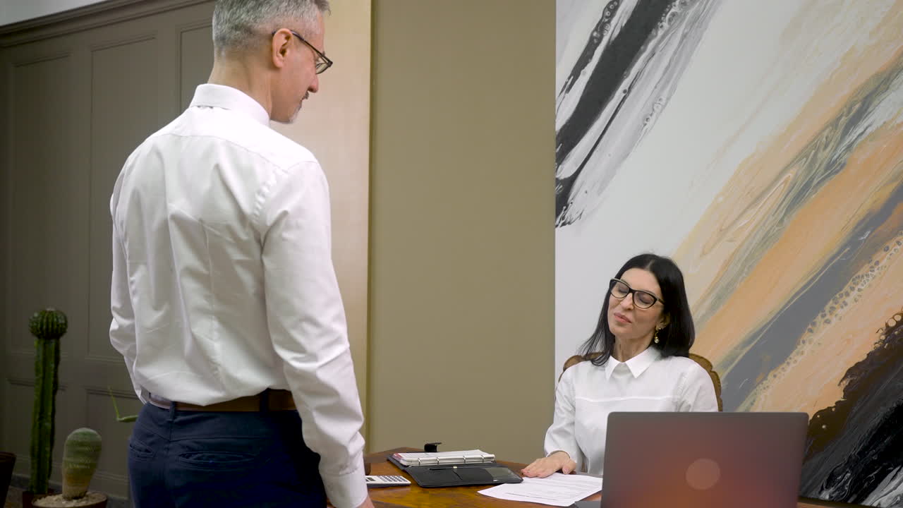 Premium stock video - Male employee giving document to his boss and ...