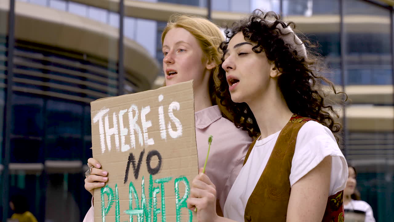 Premium stock video - Women holding there is no planet b board and ...