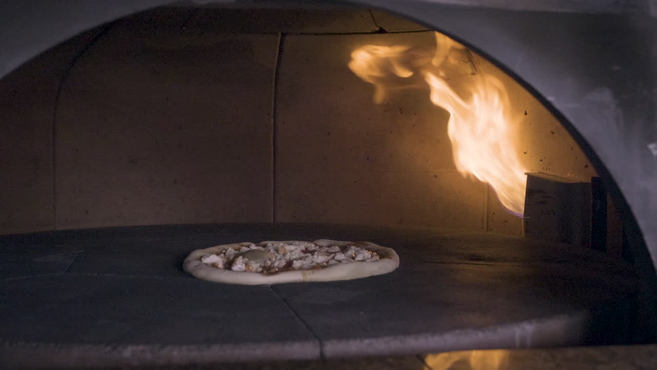 Premium stock video - Pizza spinning in the stone oven in a restaurant ...