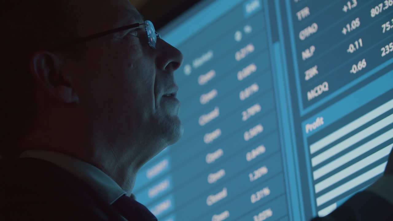 Premium stock video - Man in eyeglasses looking at big digital screen ...