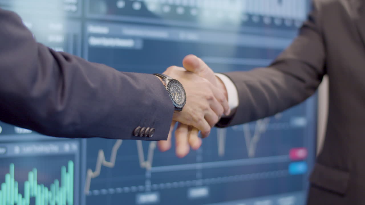 Premium stock video - Data engineers shaking hands in meeting room