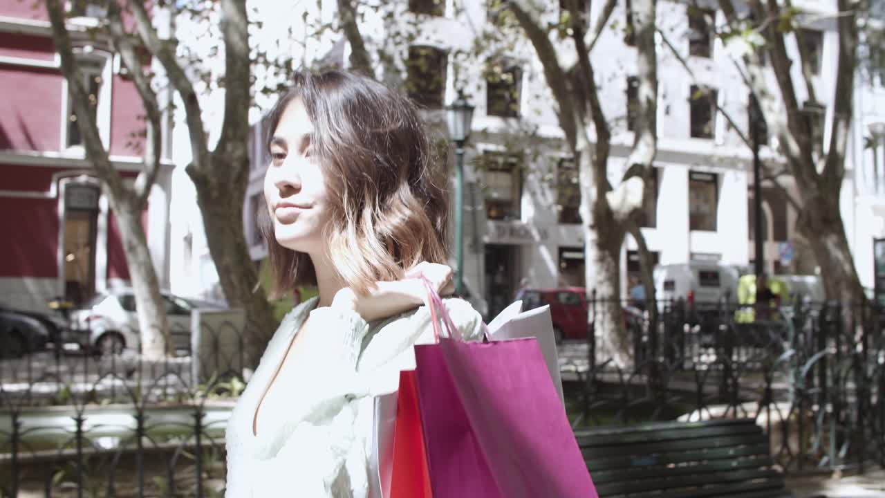 Free stock video - Young beautiful woman holding bags on shoulder and ...
