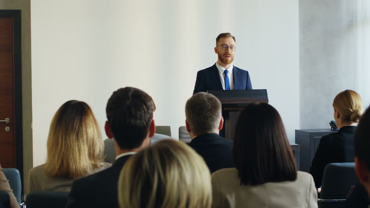 Free stock video - Caucasian businessman speaker on a podium wearing ...