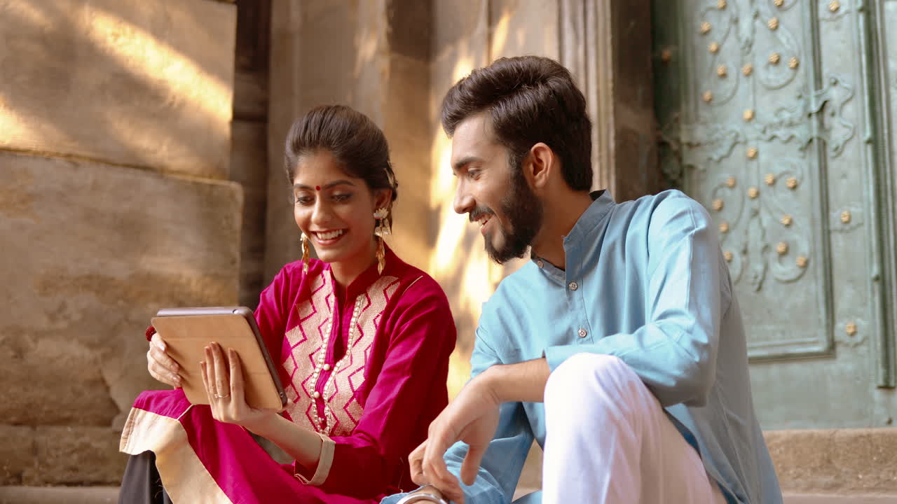 Free stock video - Young indian couple sitting in front of a door