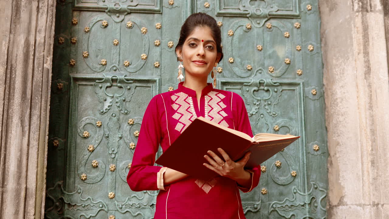 Free stock video - Beautiful indian woman in red reading a book