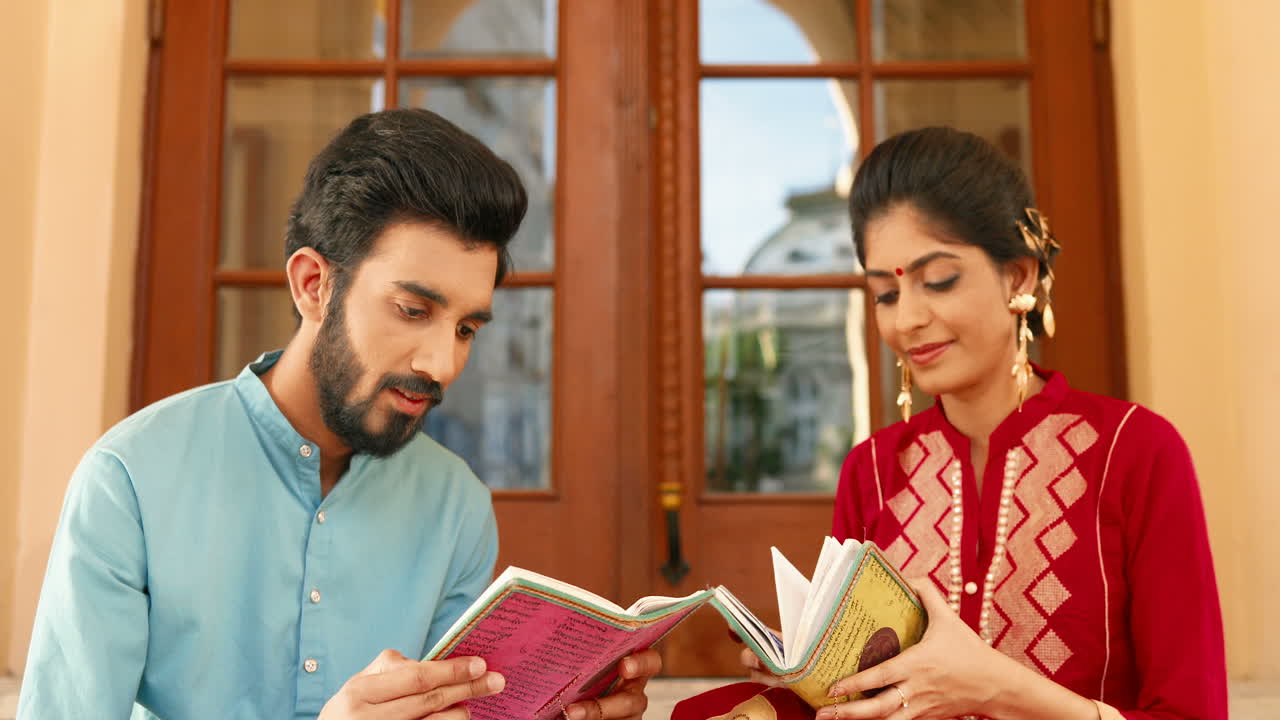 Free stock video - Portrait of indian couple reading books and smiling Free stock video - Portrait of indian couple reading books and smiling