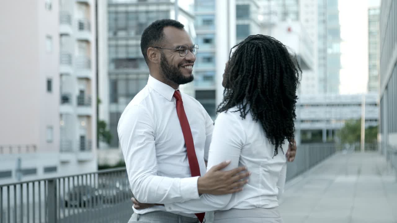 Free stock video - Cheerful colleagues hugging on street