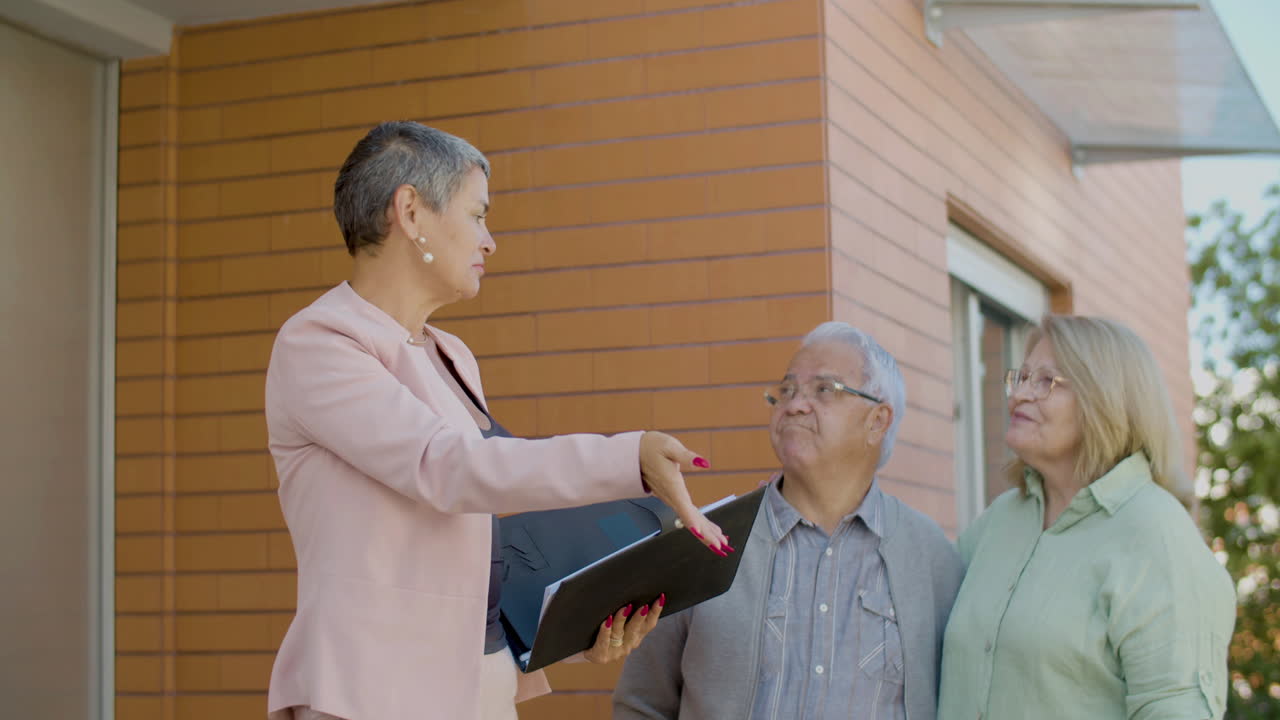 Free stock video - Senior couple with real estate agent visiting house ...