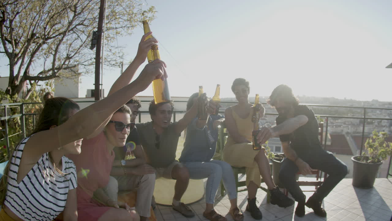 Free stock video - Happy friends raising bottles of beer up and ...