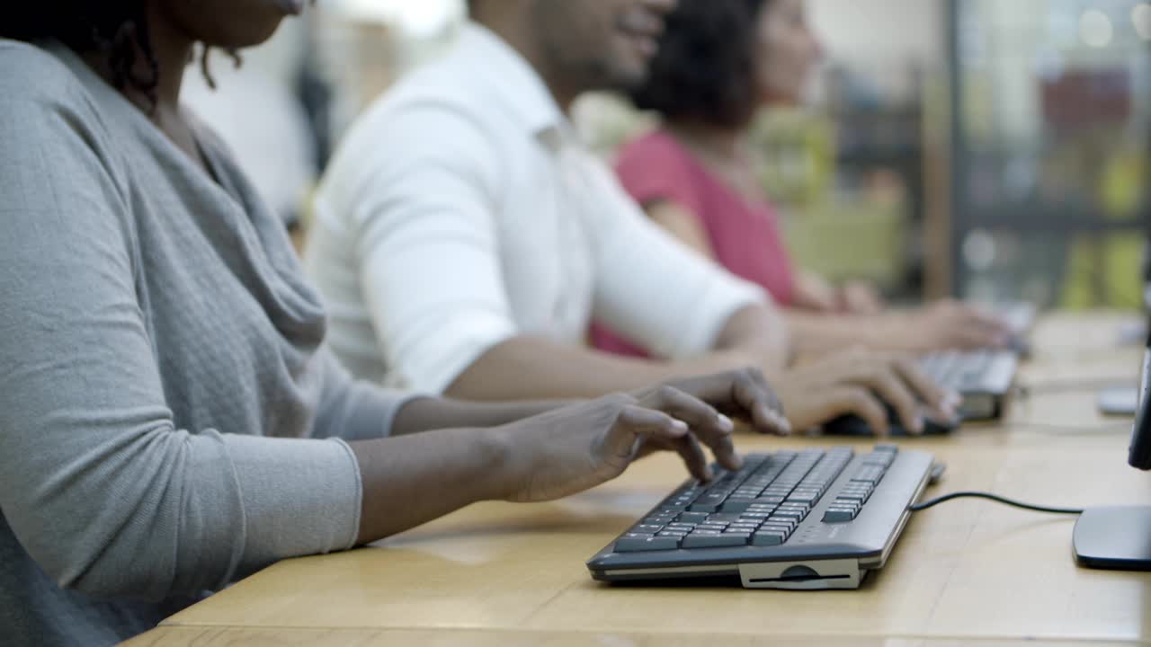 Free stock video - Closeup shot of people working with computers at tables