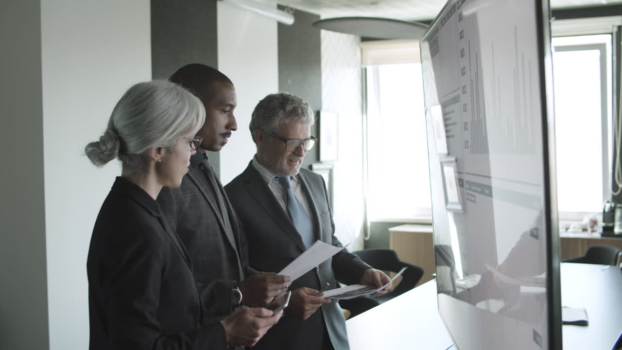 Free stock video - Group of experts analyzing financial market