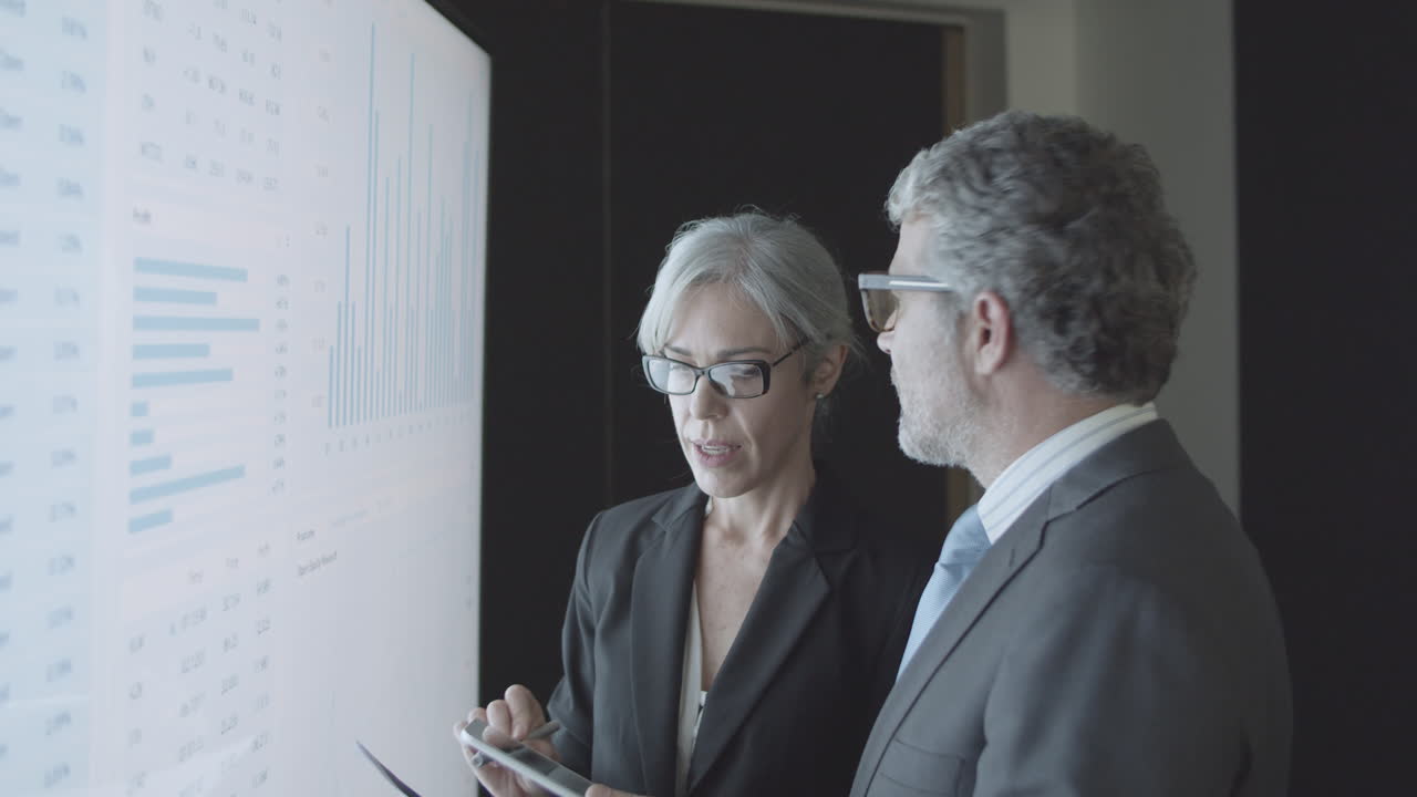 Free stock video - Female finance expert explaining stock market statistics