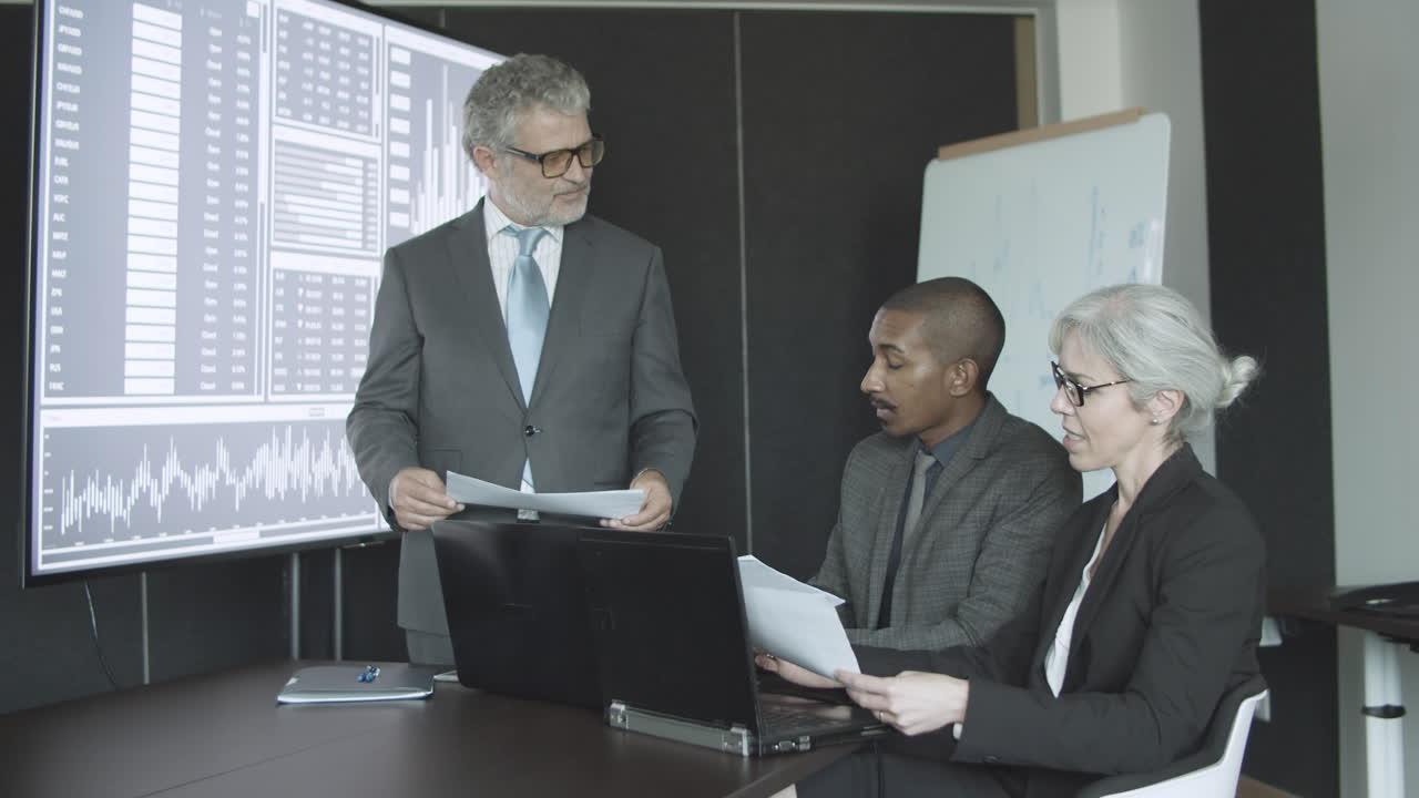 Free stock video - Financial advisor meeting with clients in boardroom