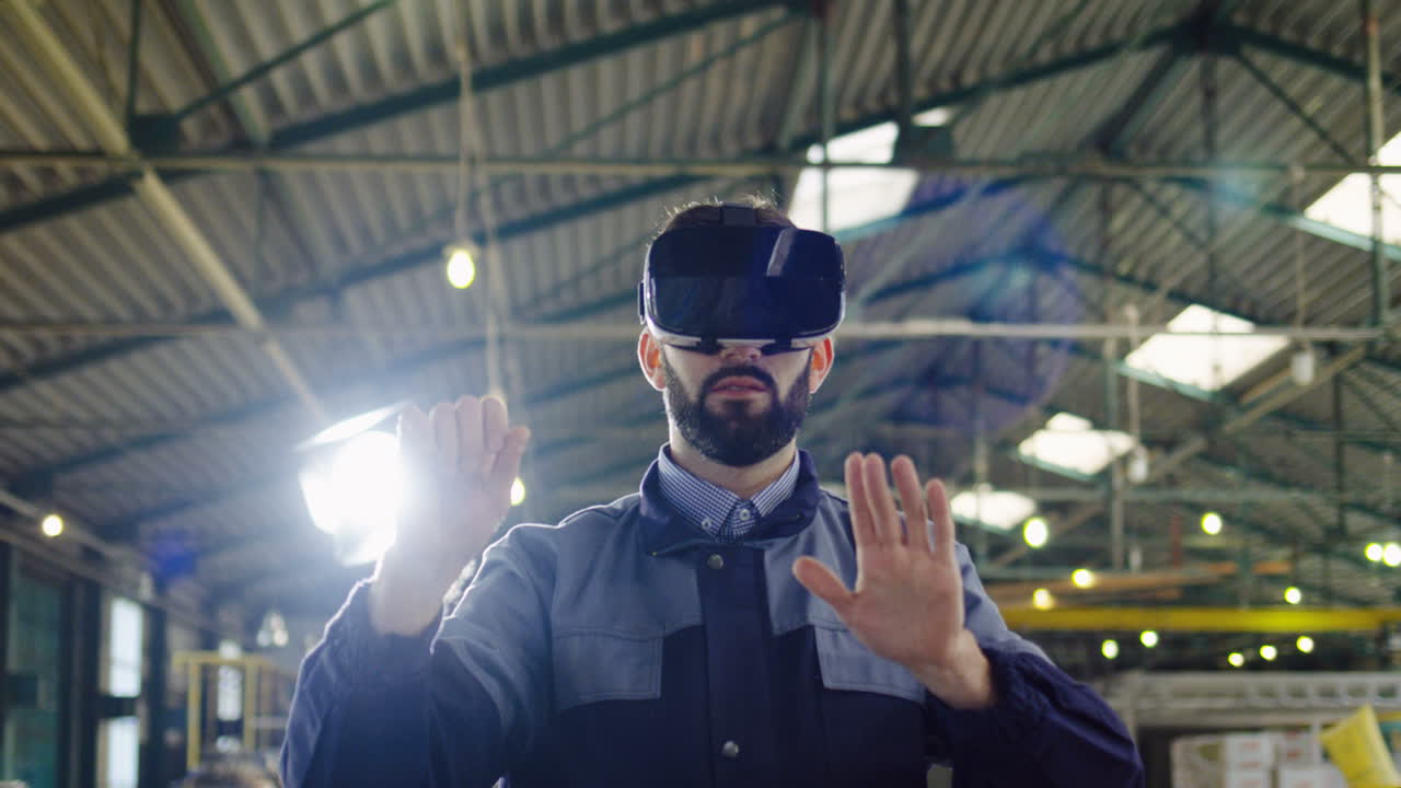 Free stock video - Male factory worker wearing vr headset in a big factory