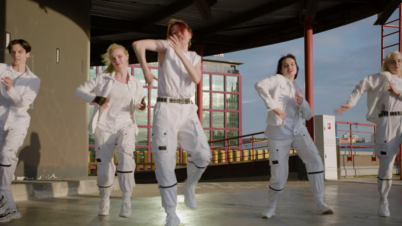 Free stock video - Young crew dancing in white outfit outdoors