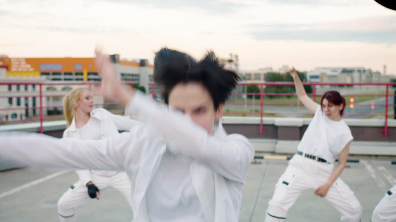 Free stock video - Front view of girl group dancing on the top of a ...