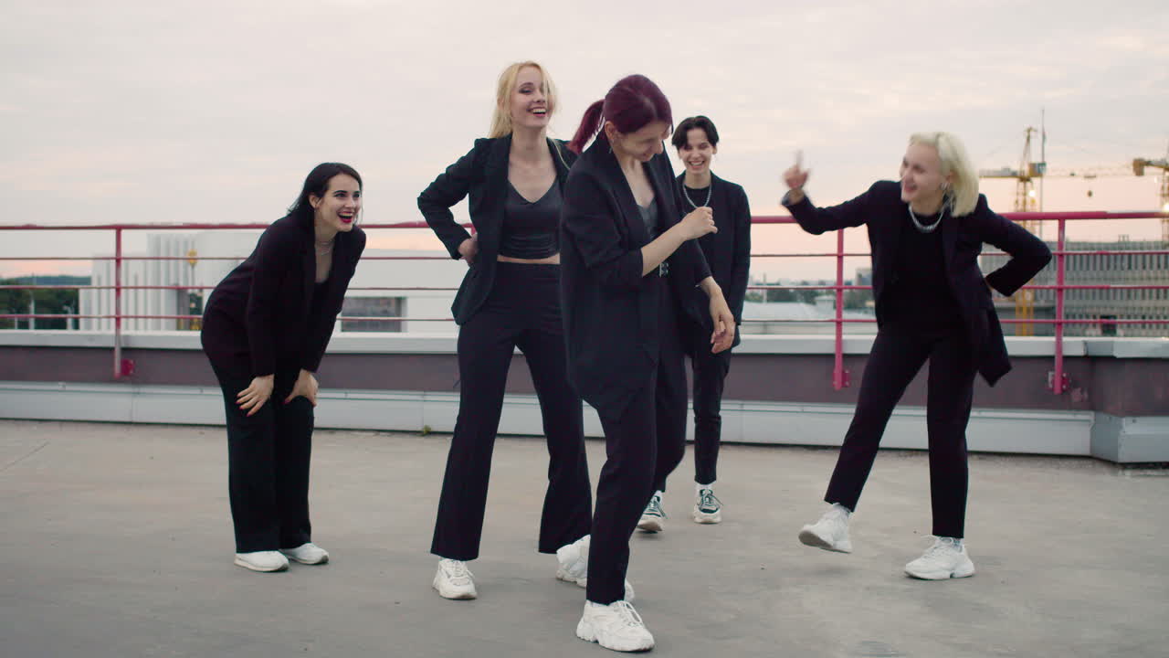 Free stock video - Girls practicing dance moves on top of the building