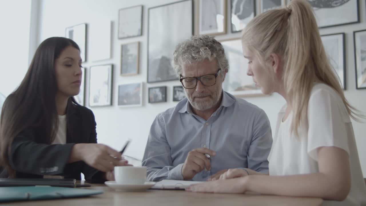 Free stock video - Consultants helping client to complete application