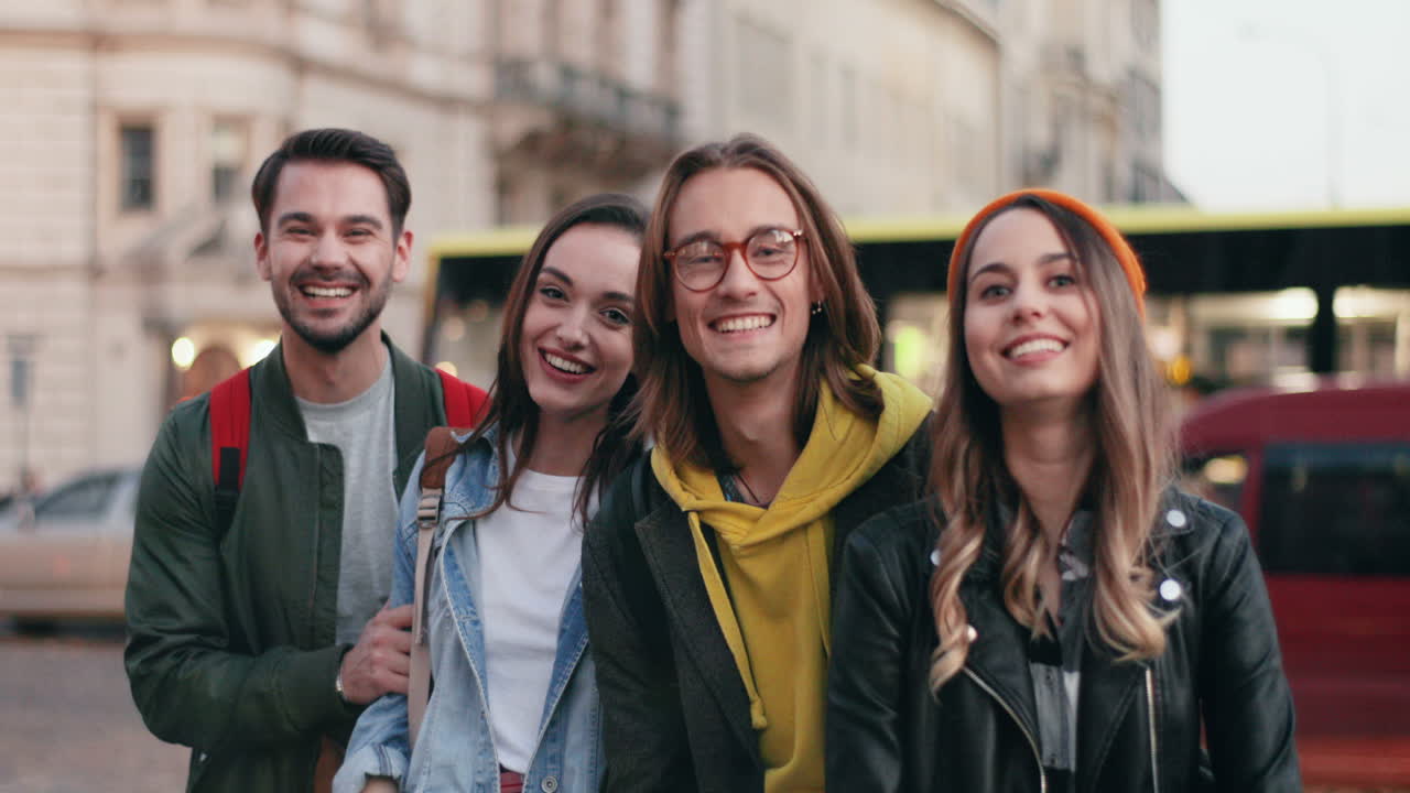 Free stock video - Caucasian group of friends together in the street and smiling at the camera