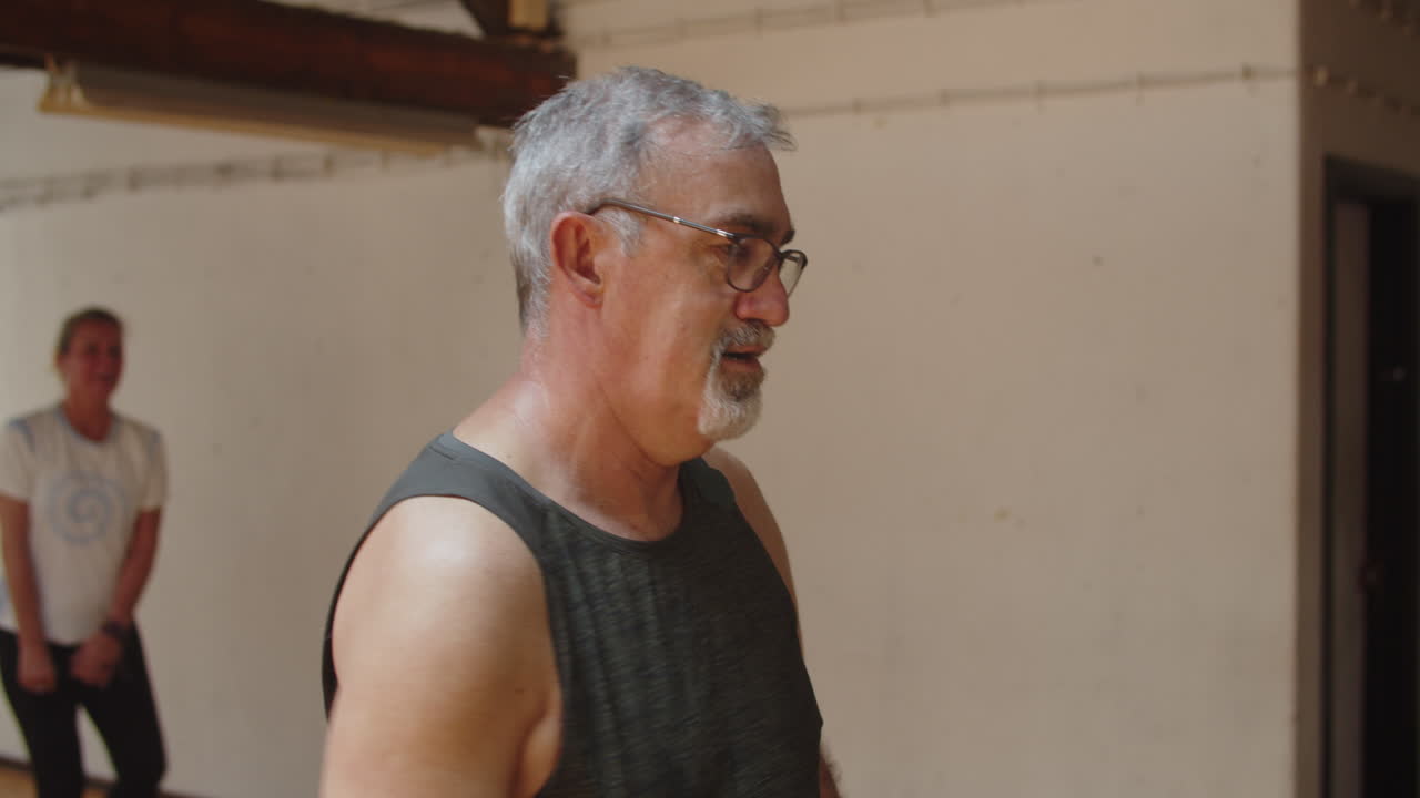 Free stock video - Medium shot of senior man having dance class in studio