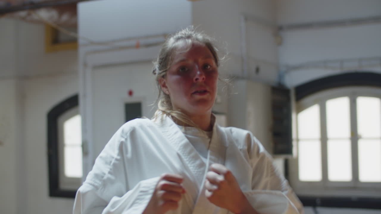 Free stock video - Handheld shot of focused karateka doing jump kicks ...