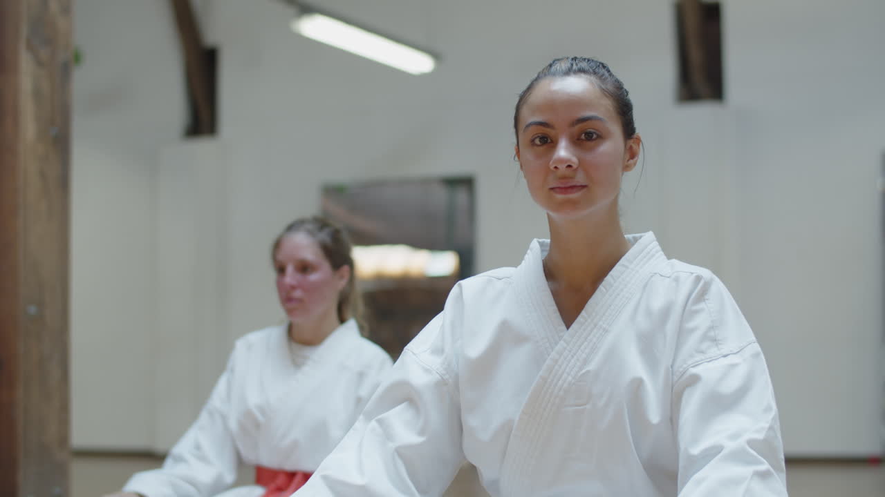Free Stock Video Front View Of Cute Karateka Sitting In Lotus Position On Floor