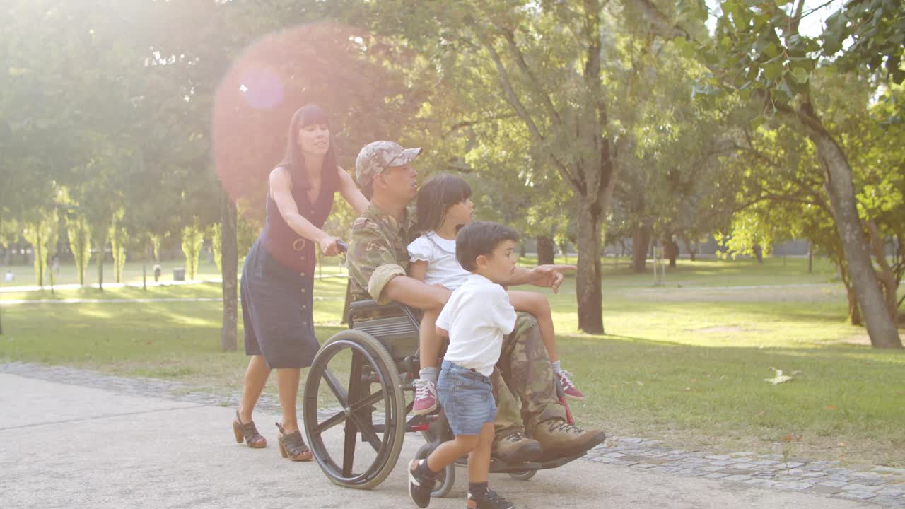 Free stock video - Disabled soldier walking with kids and wife