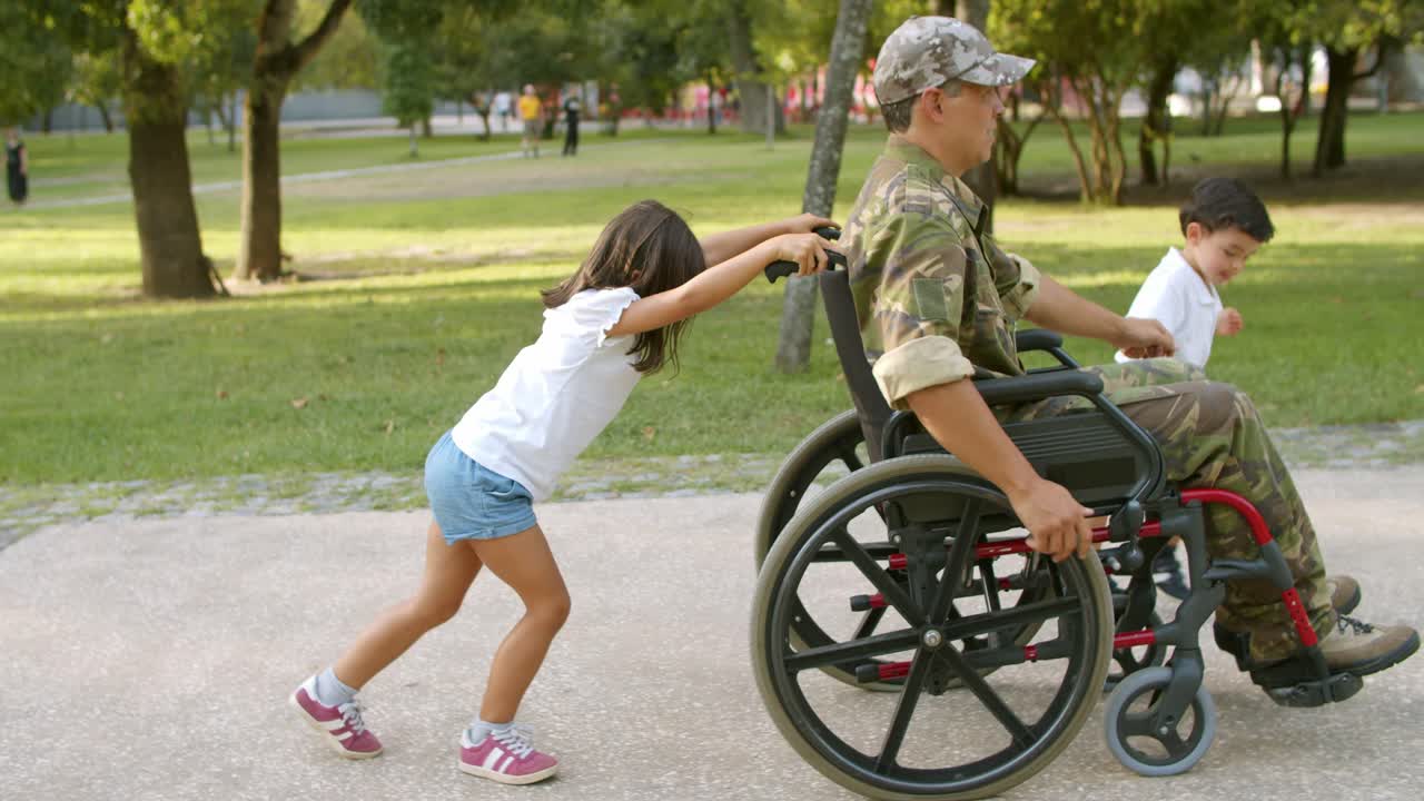 Free stock video - Kids helping disabled military dad to wheel heavy ...