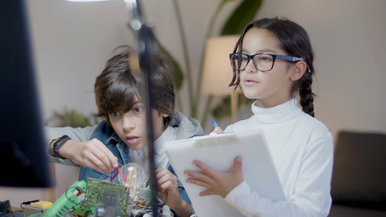 Free stock video - Two smart children doing school project in engineering