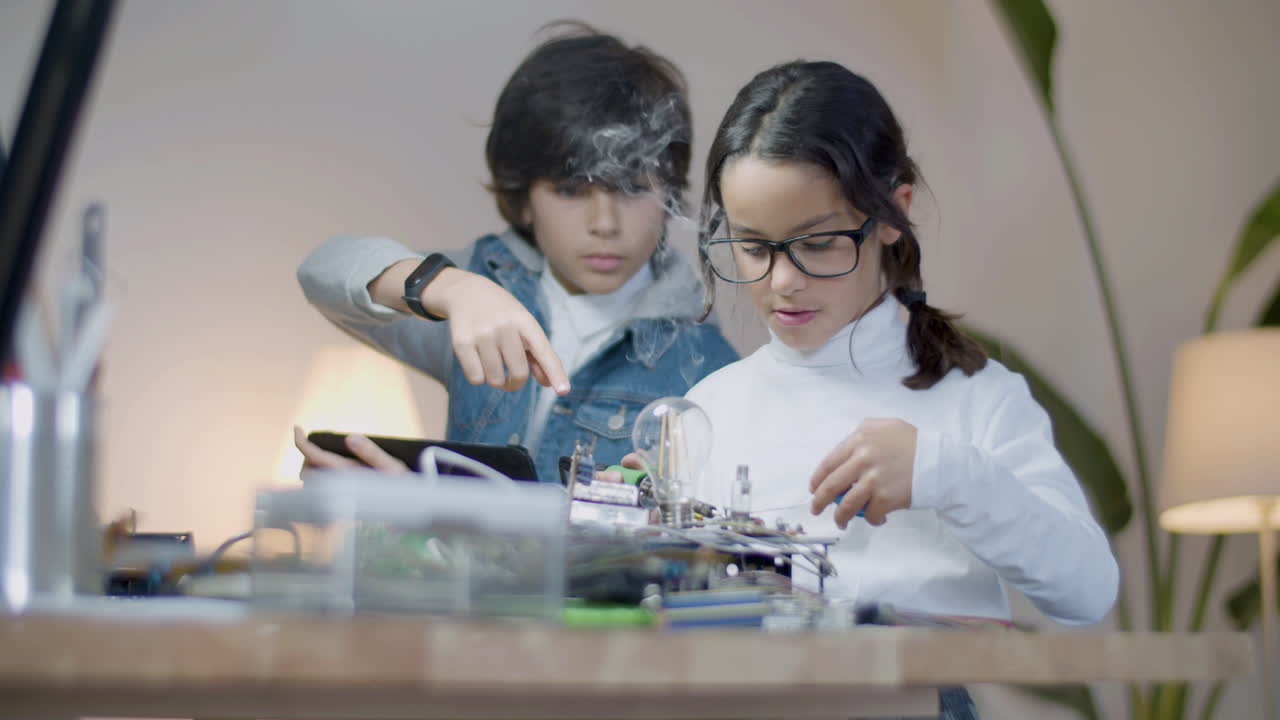 Free stock video - Two kids doing school project in engineering