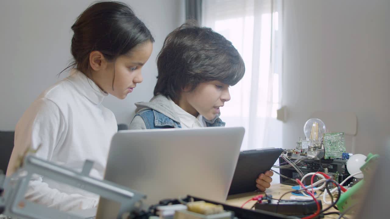 Free stock video - Two children doing interesting project together