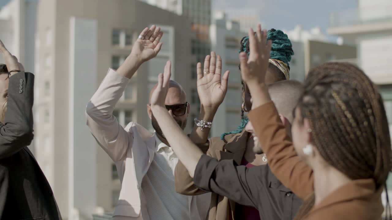 Free stock video - Medium shot of excited colleagues giving high five ...