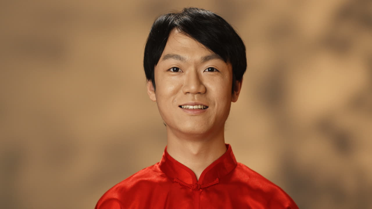 Free stock video - Close-up view of cheerful young asian man in red traditional costume smiling ...