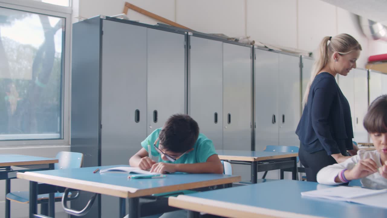 Free stock video - Friendly school teacher giving help to pupils