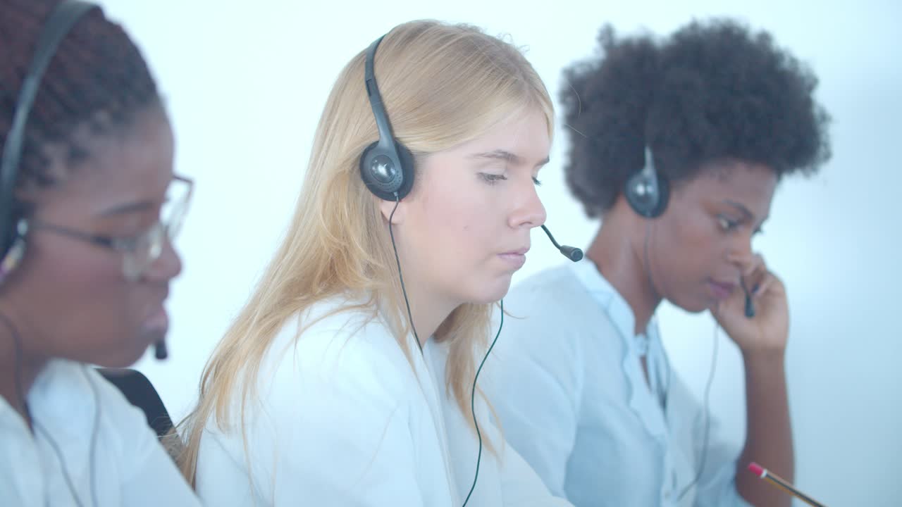 Free stock video - Row of diverse female call center operators in ...