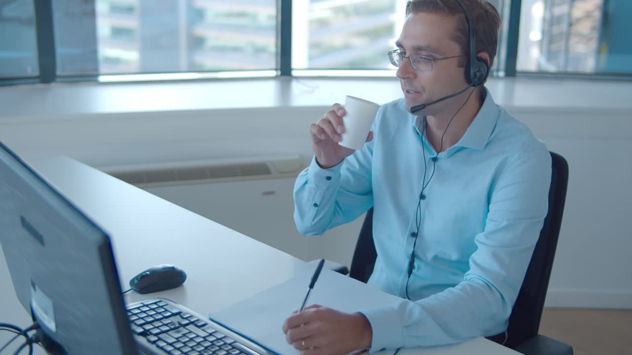 Free stock video - Positive male operator in headset taking call and ...