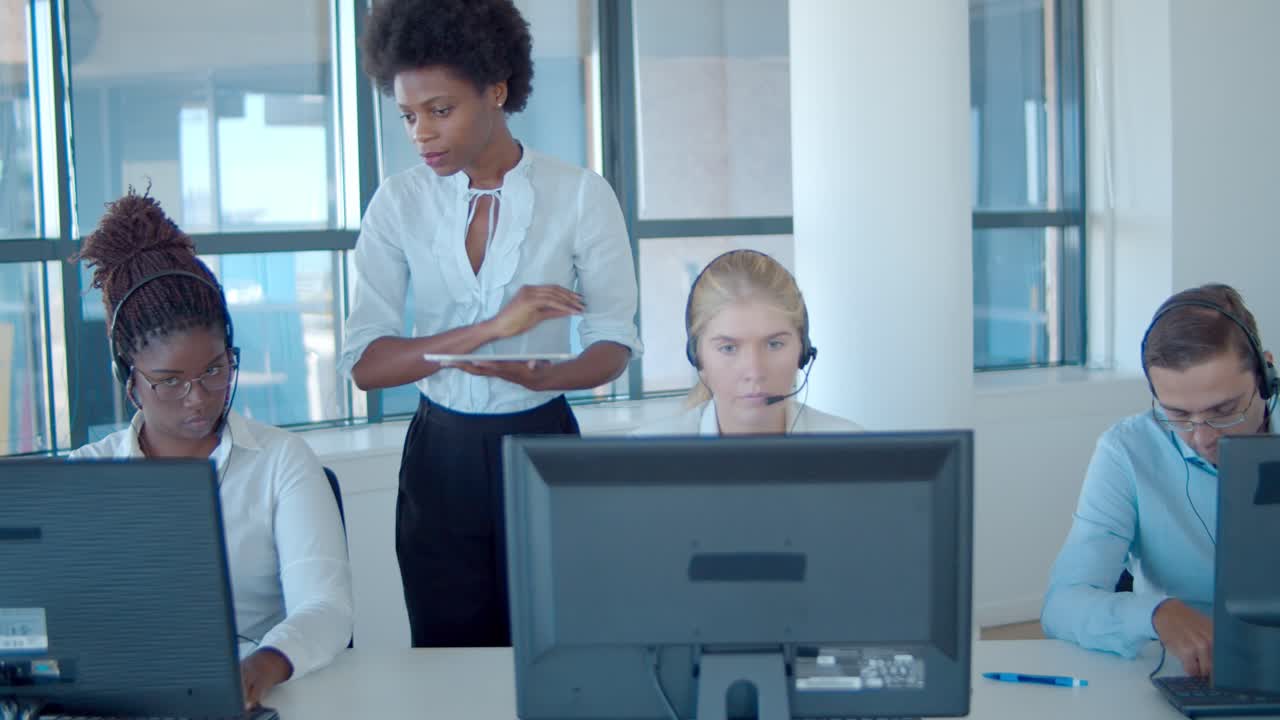 Free stock video - Serious female call center leader helping employee ...