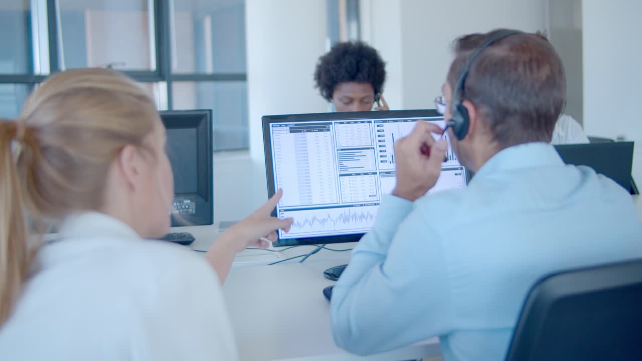 Free stock video - Mentor teaching employee to work with financial data