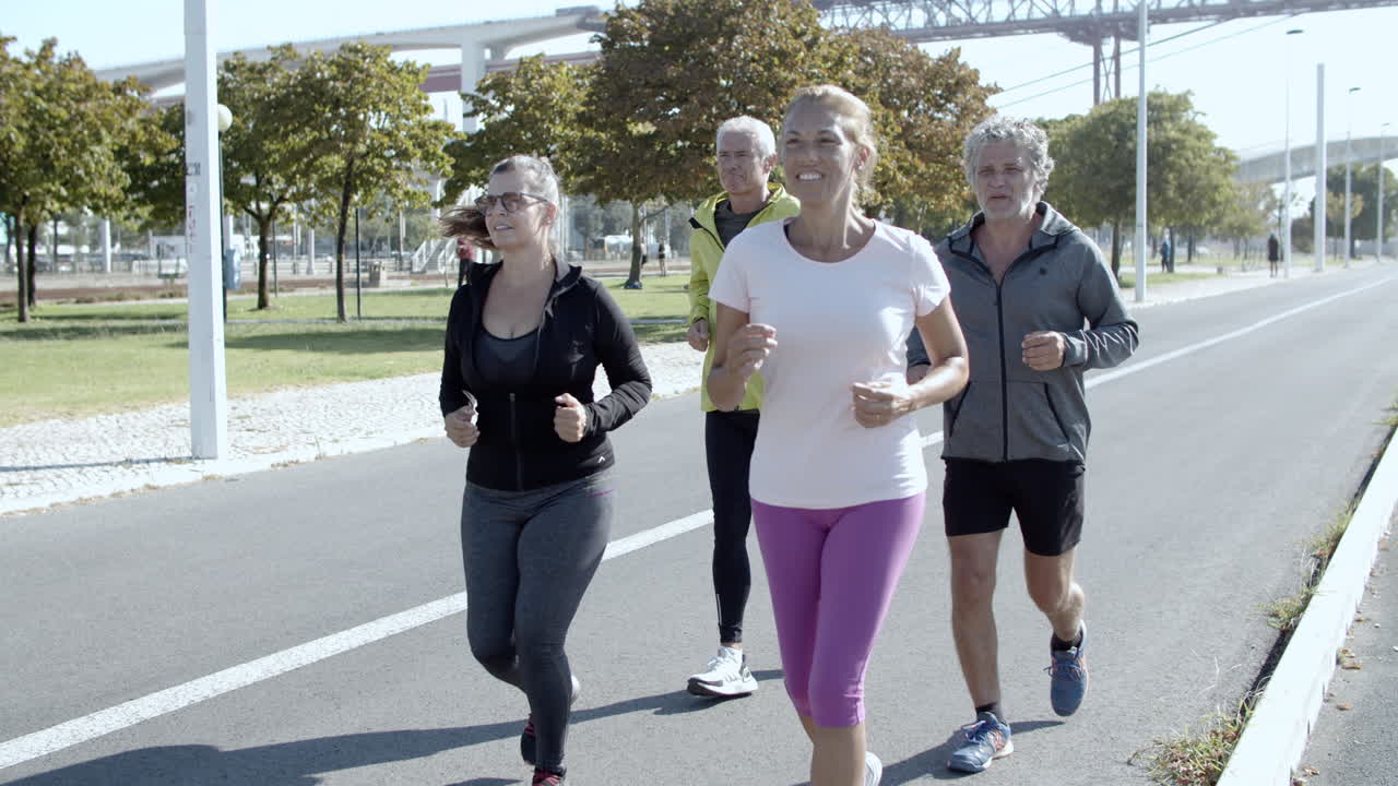 Free stock video - Active elder joggers running down street
