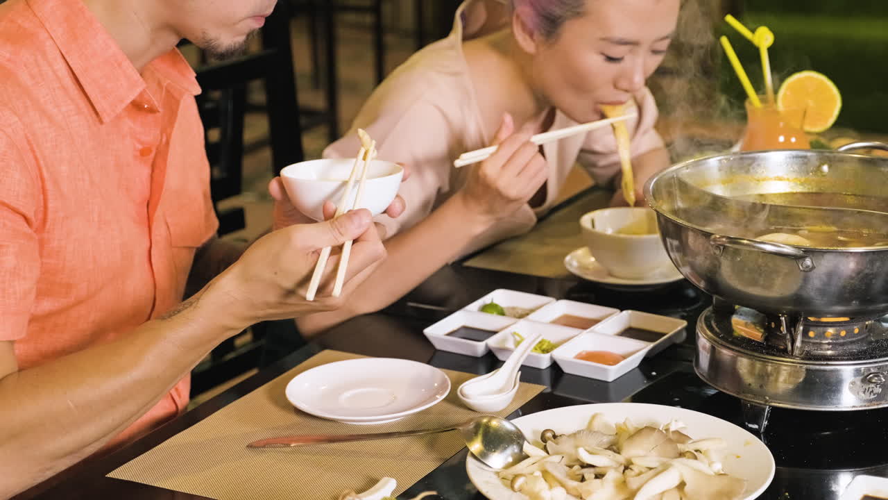 Free stock video - Unrecognizable people eating delicious chinese food