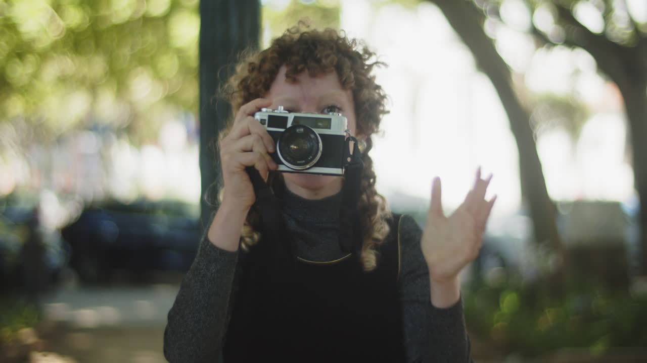 Free stock video - Happy female photographer taking pictures outdoors Free stock video - Happy female photographer taking pictures outdoors