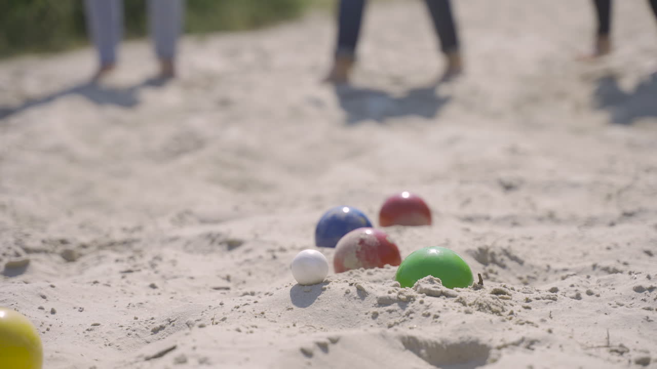 Free stock video - Close-up view of colorful petanque balls on the sand ...