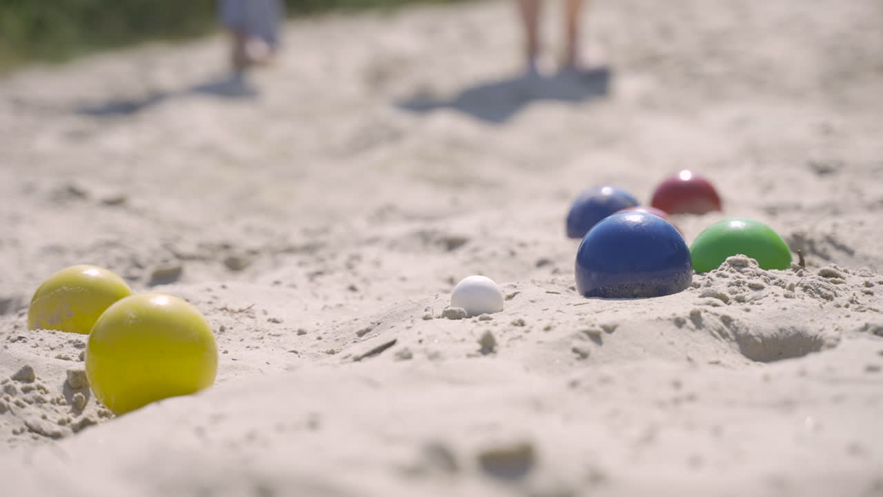 Free stock video - Close-up view of colorful petanque balls on the sand ...