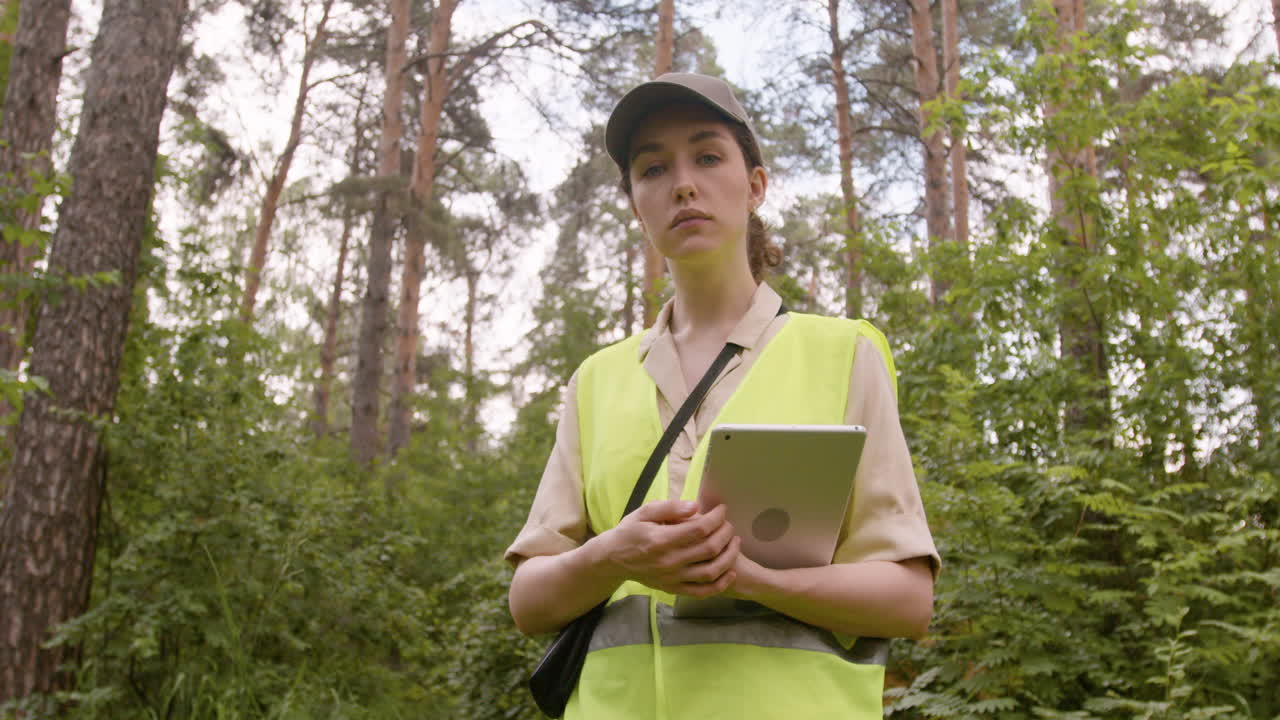 Free stock video - Caucasian female forest warden holding a tablet in ...