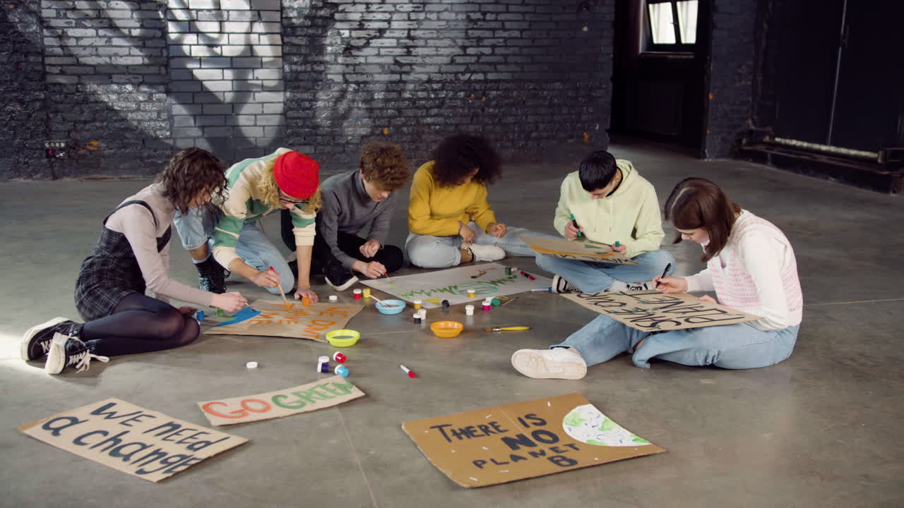 Free stock video - Young environmental activists painting placards ...